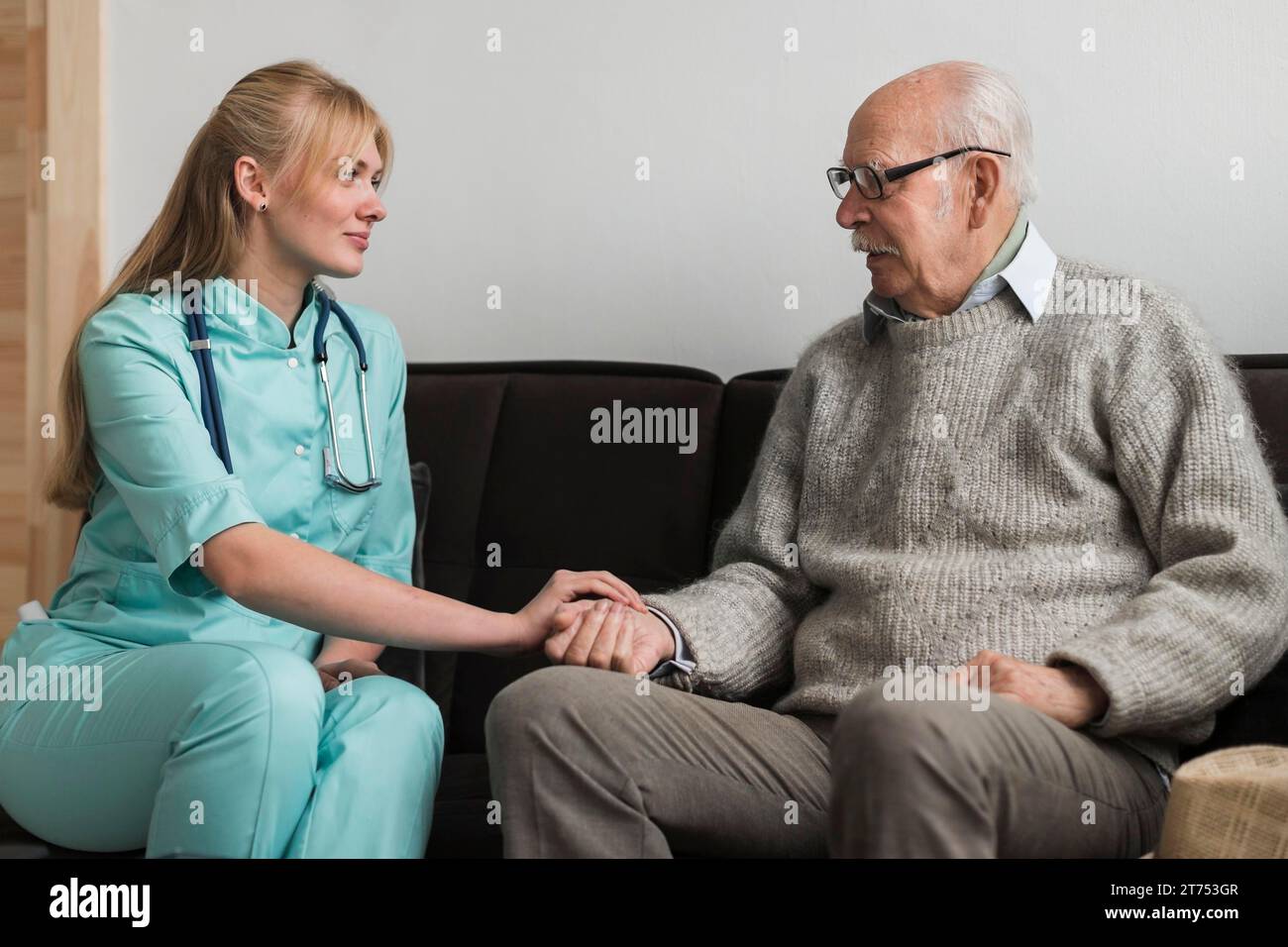 Nurse holding old man s hand nursing home Stock Photo - Alamy