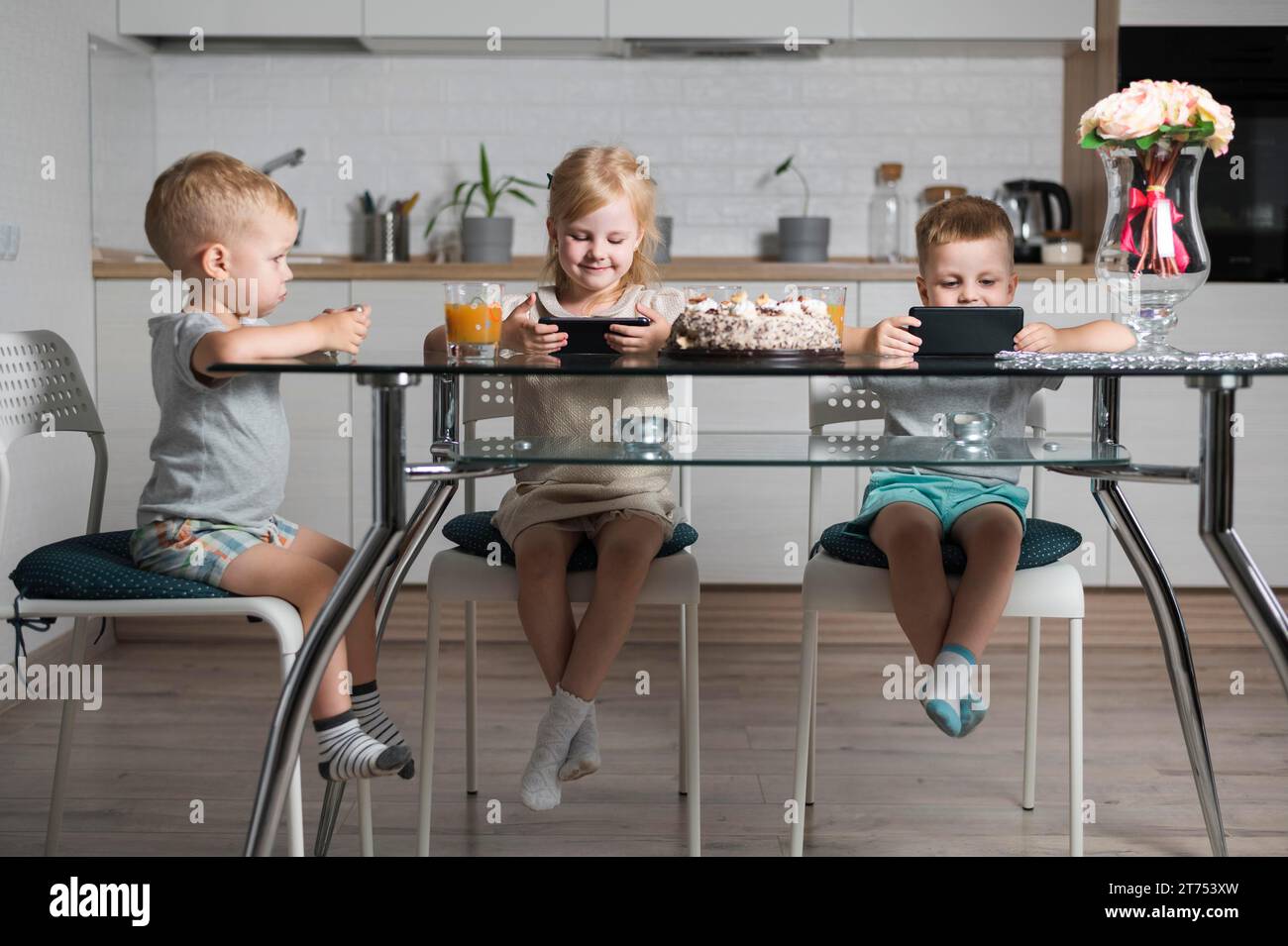Happy siblings playing phones hi-res stock photography and images - Alamy