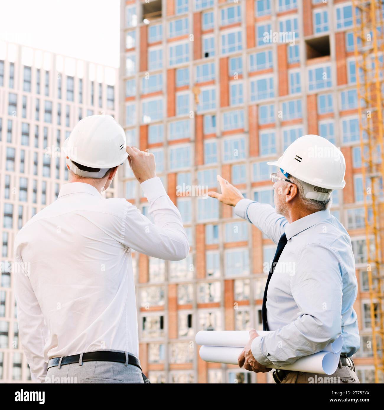 Side view man pointing building scaffolding Stock Photo - Alamy