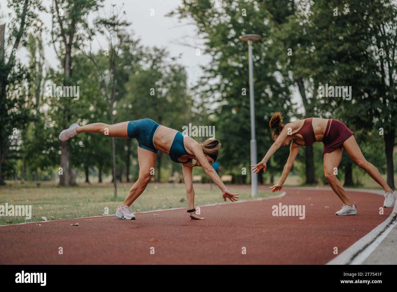 Fit sisters performing impressive flips and cartwheels in a park ...