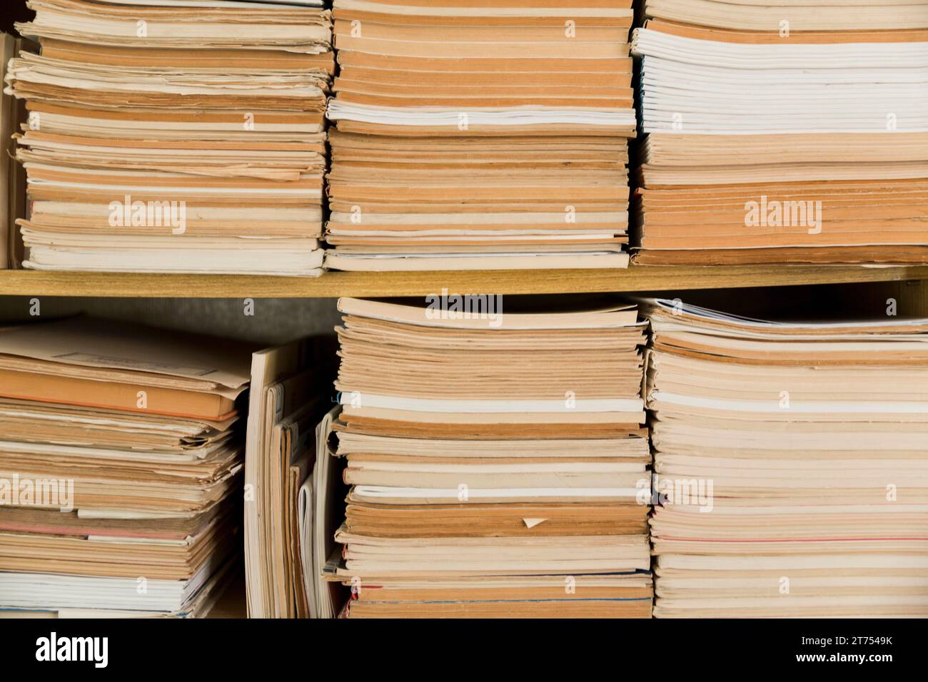 Stacked old notepads shelf Stock Photo - Alamy