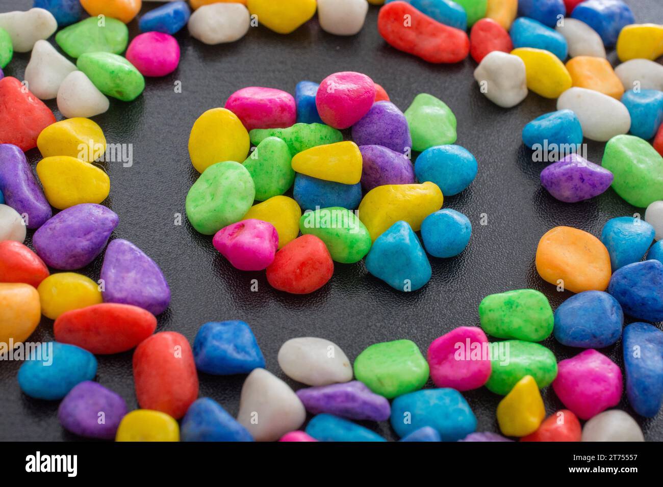 Pile of little colorful pebbles on black background Stock Photo - Alamy