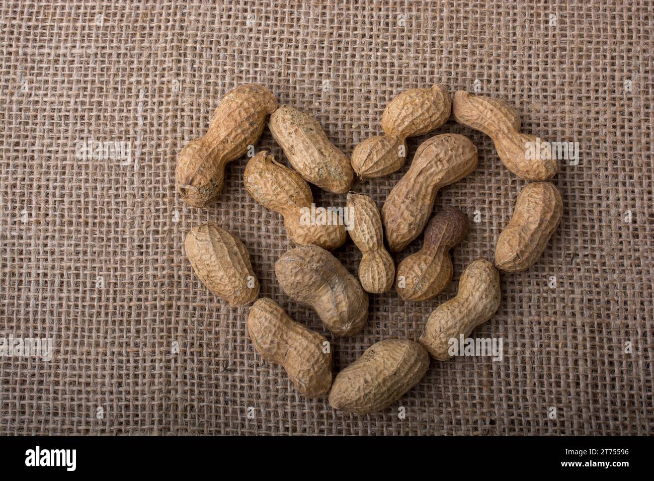 Peanuts form a heart shape on canvas background Stock Photo - Alamy