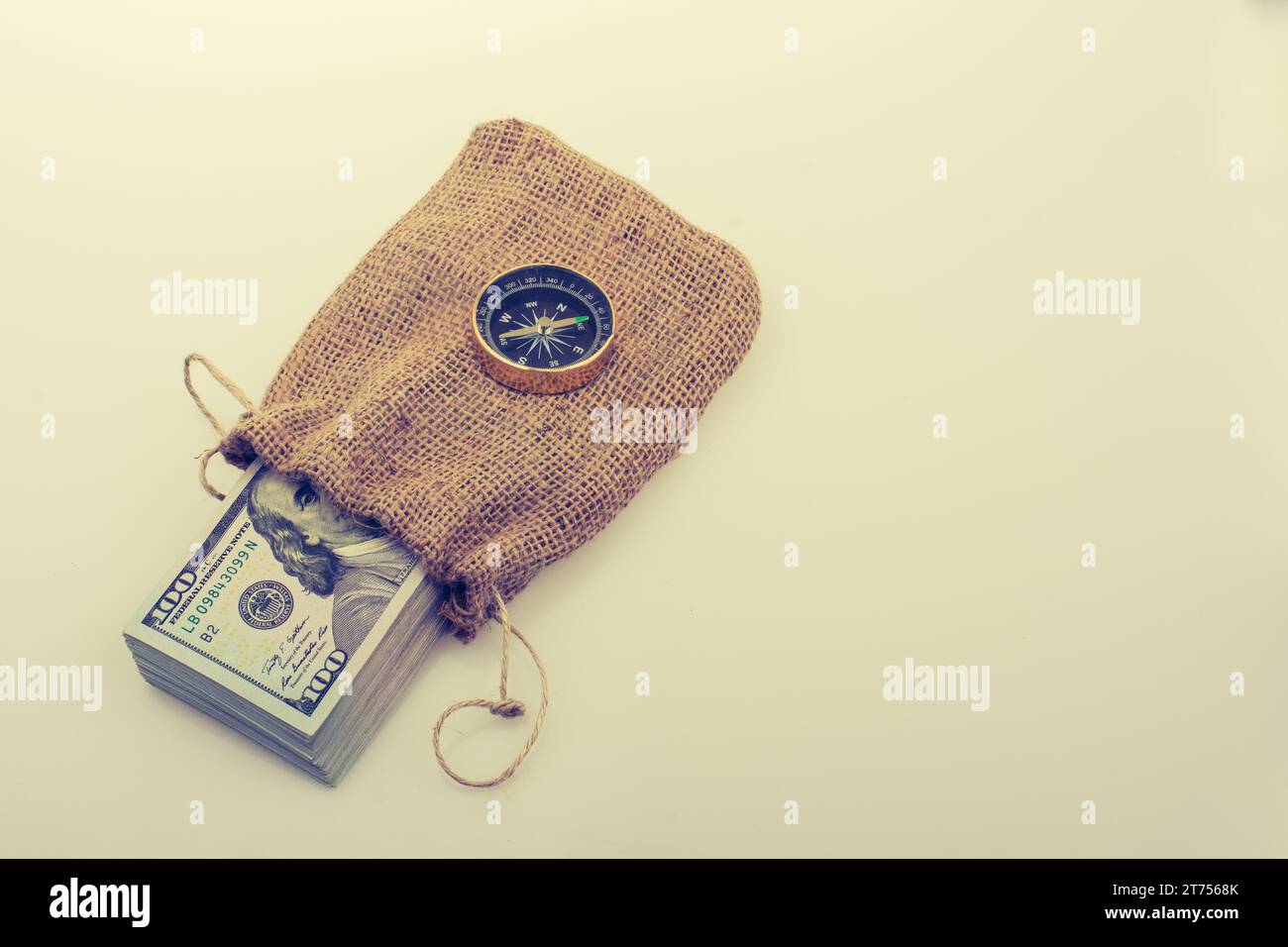 Compass and bundle of US dollarin a sack on a white background Stock ...