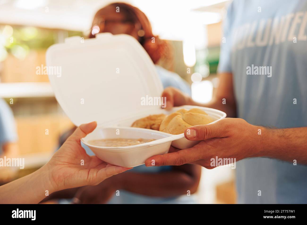 Detailed view of less fortunate woman receiving free food from male ...