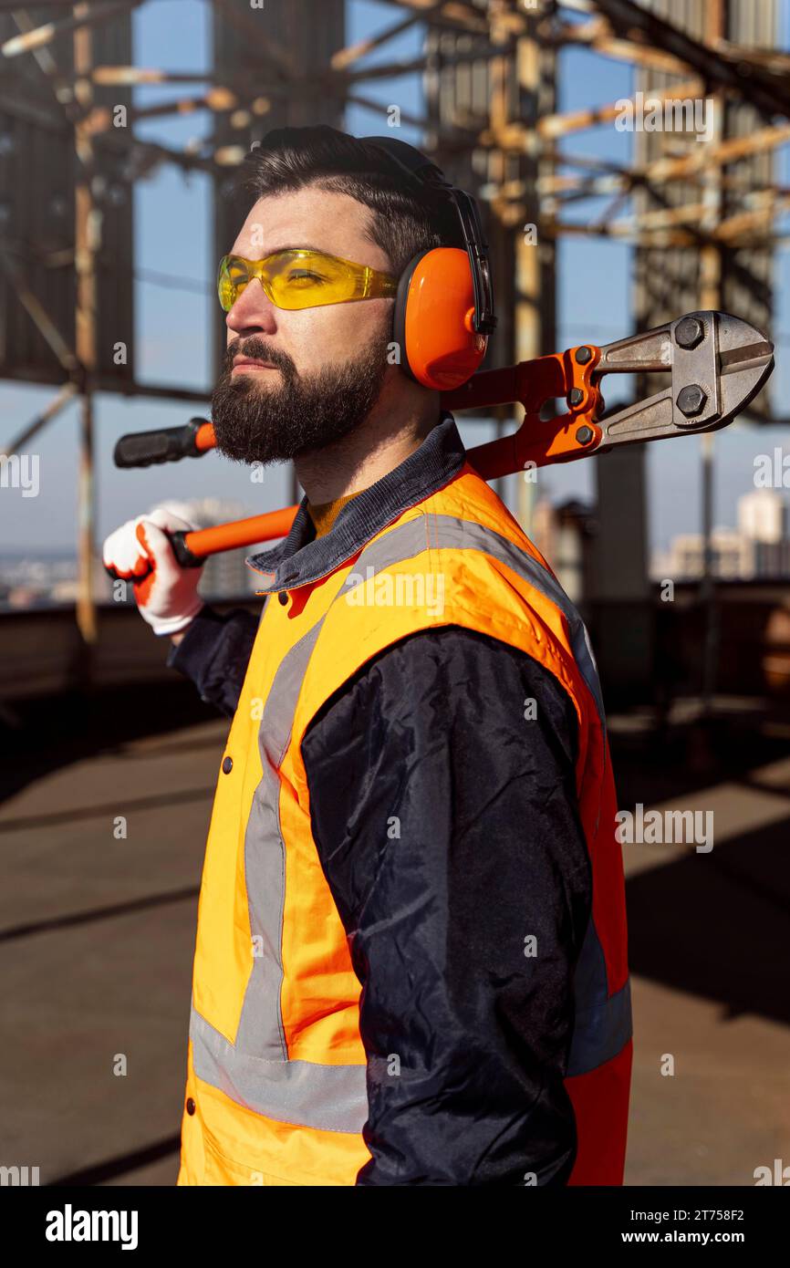 Medium shot man wearing safety equipment Stock Photo - Alamy