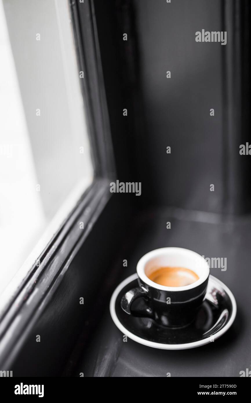 Black empty coffee cup with coffee stains window sill Stock Photo - Alamy