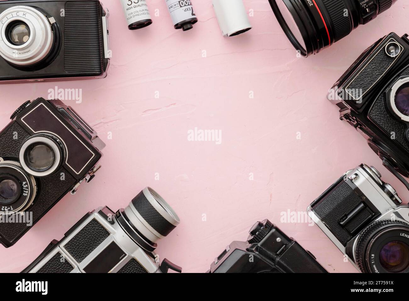 Border from cameras film pink background Stock Photo - Alamy
