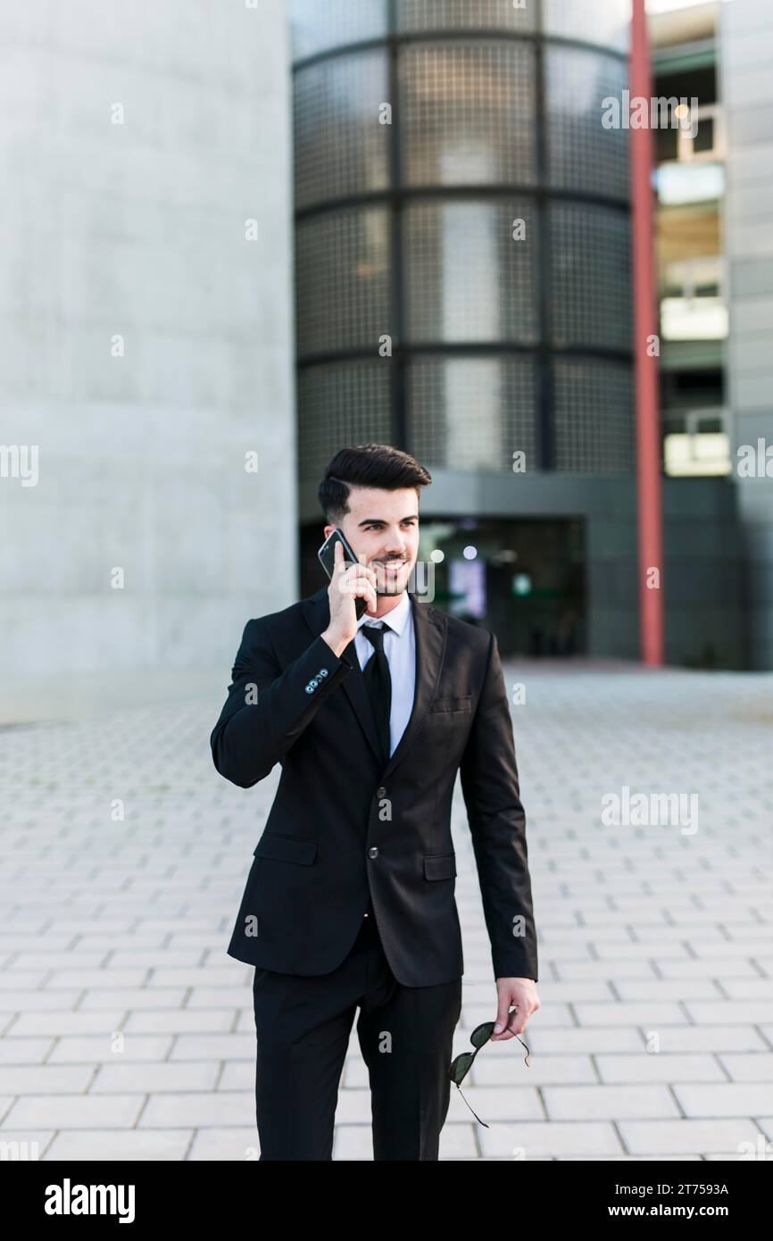 Business man front office building using his mobile phone Stock Photo ...