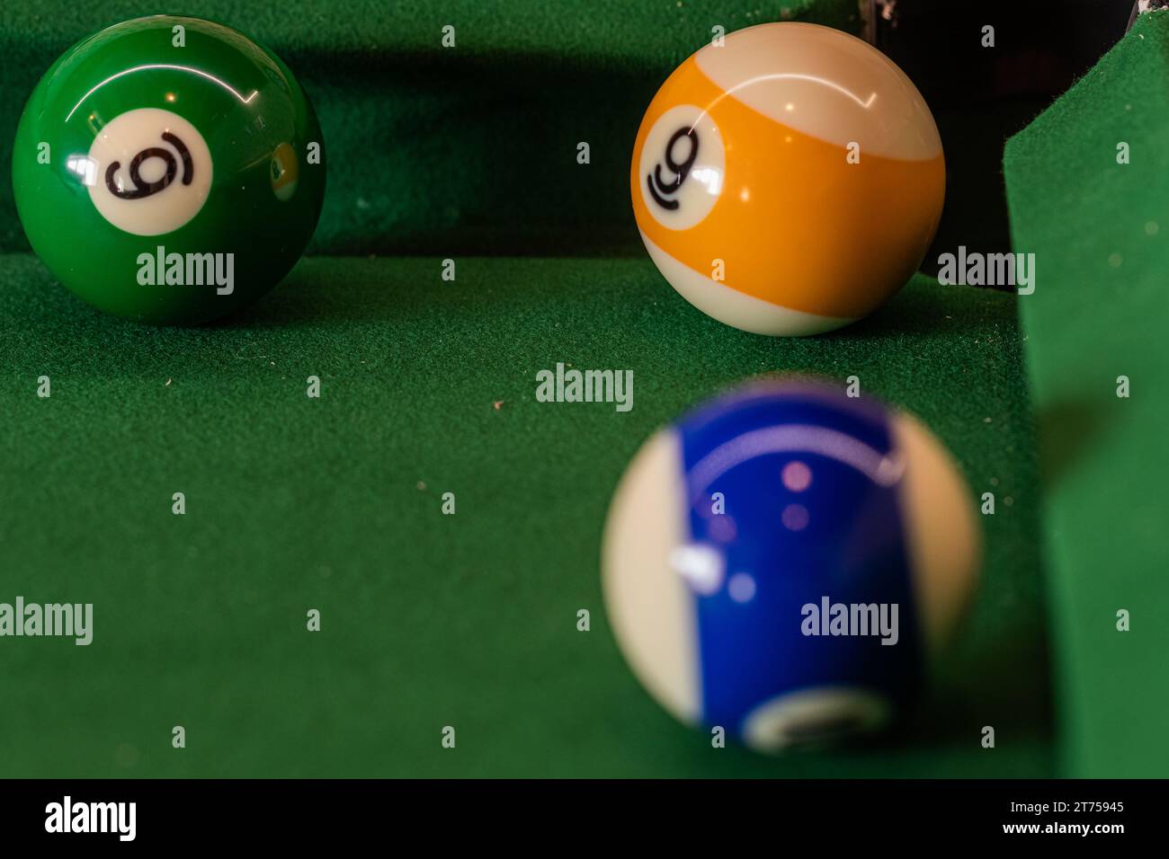 Colorful pool balls arranged on a billiard table, promising ...
