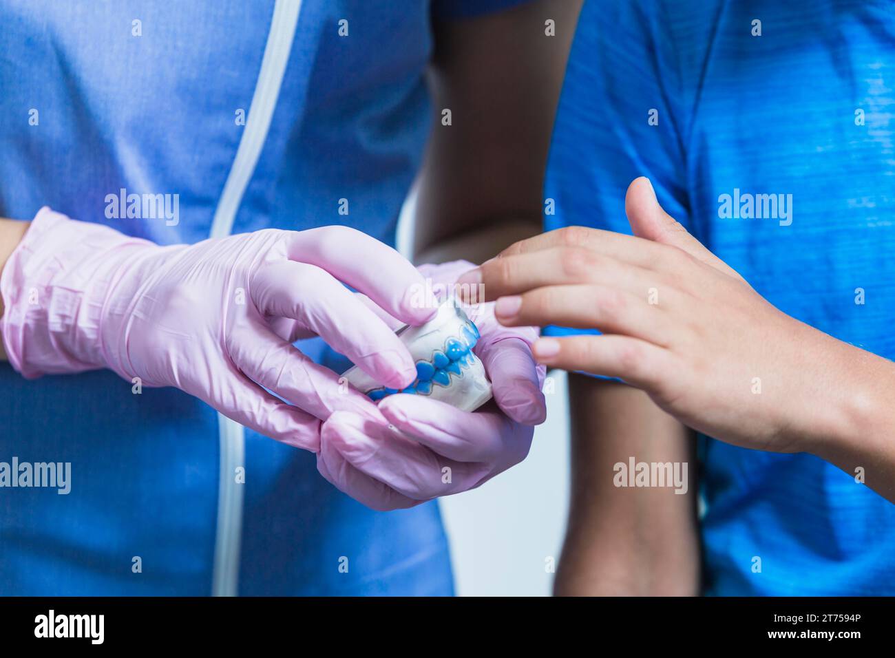 Close up boy s hand touching teeth plaster mold hold by dentist Stock ...