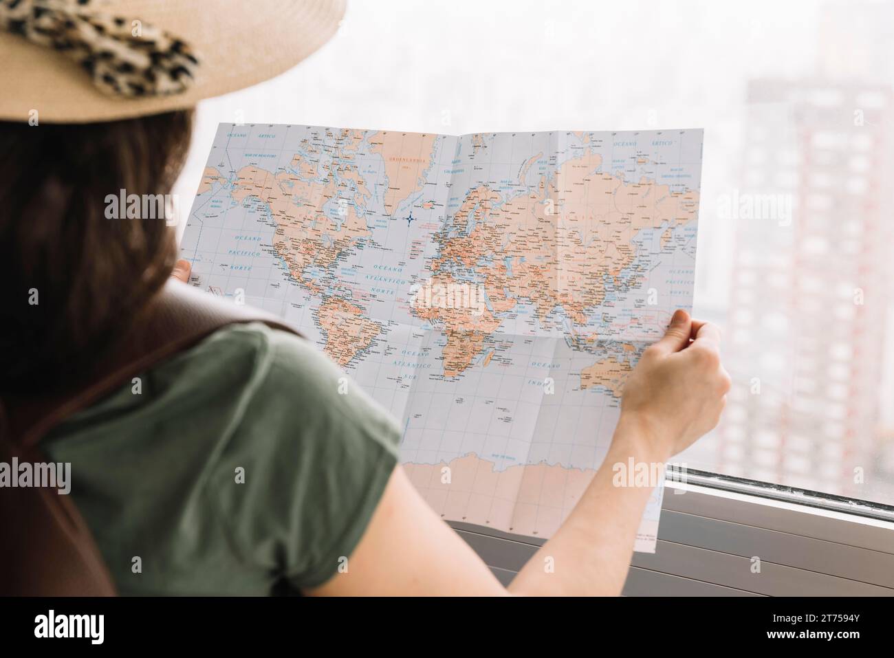 Close up female tourist reading map near window Stock Photo - Alamy