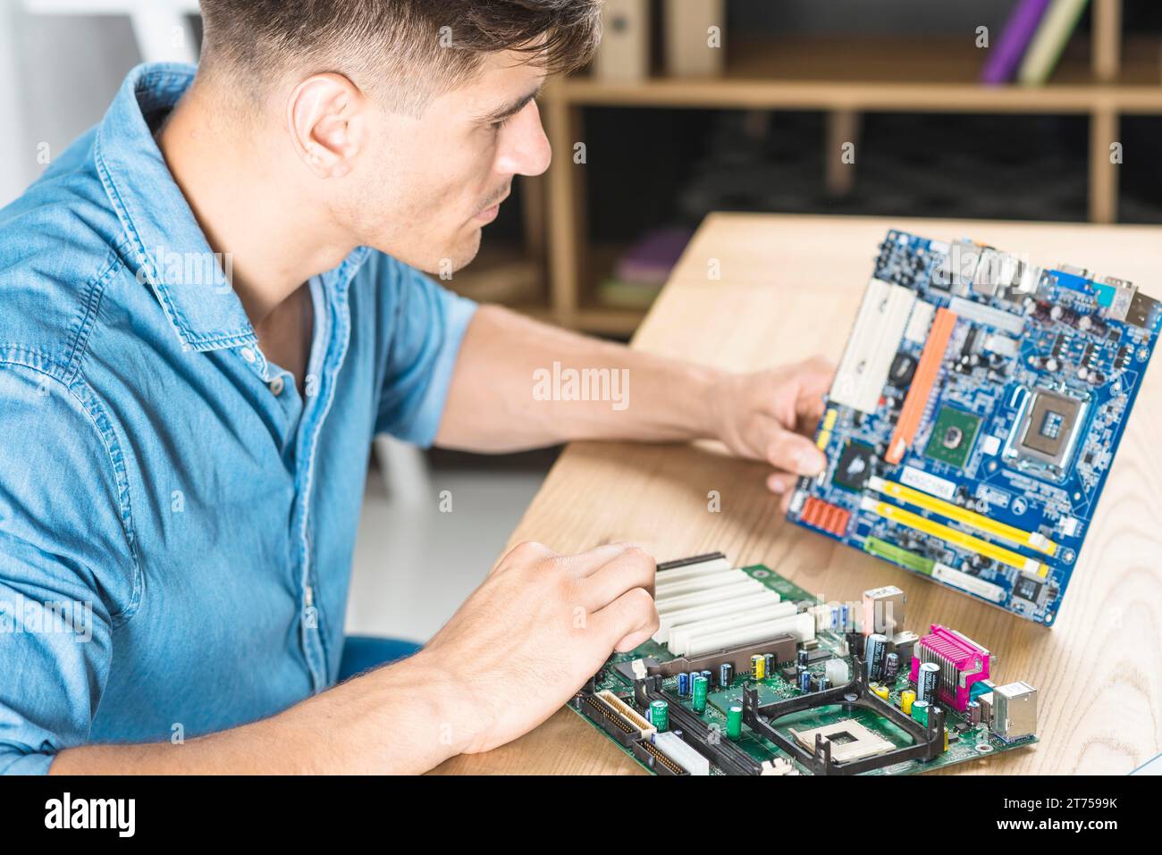 Close up it man learning motherboard circuit Stock Photo - Alamy