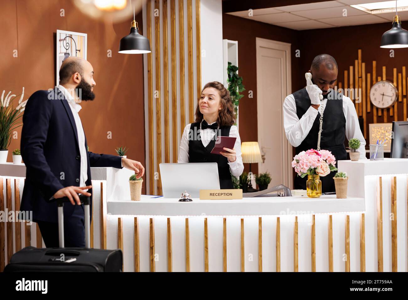 Check in procedure at hotel reception. Front desk employee checking ...