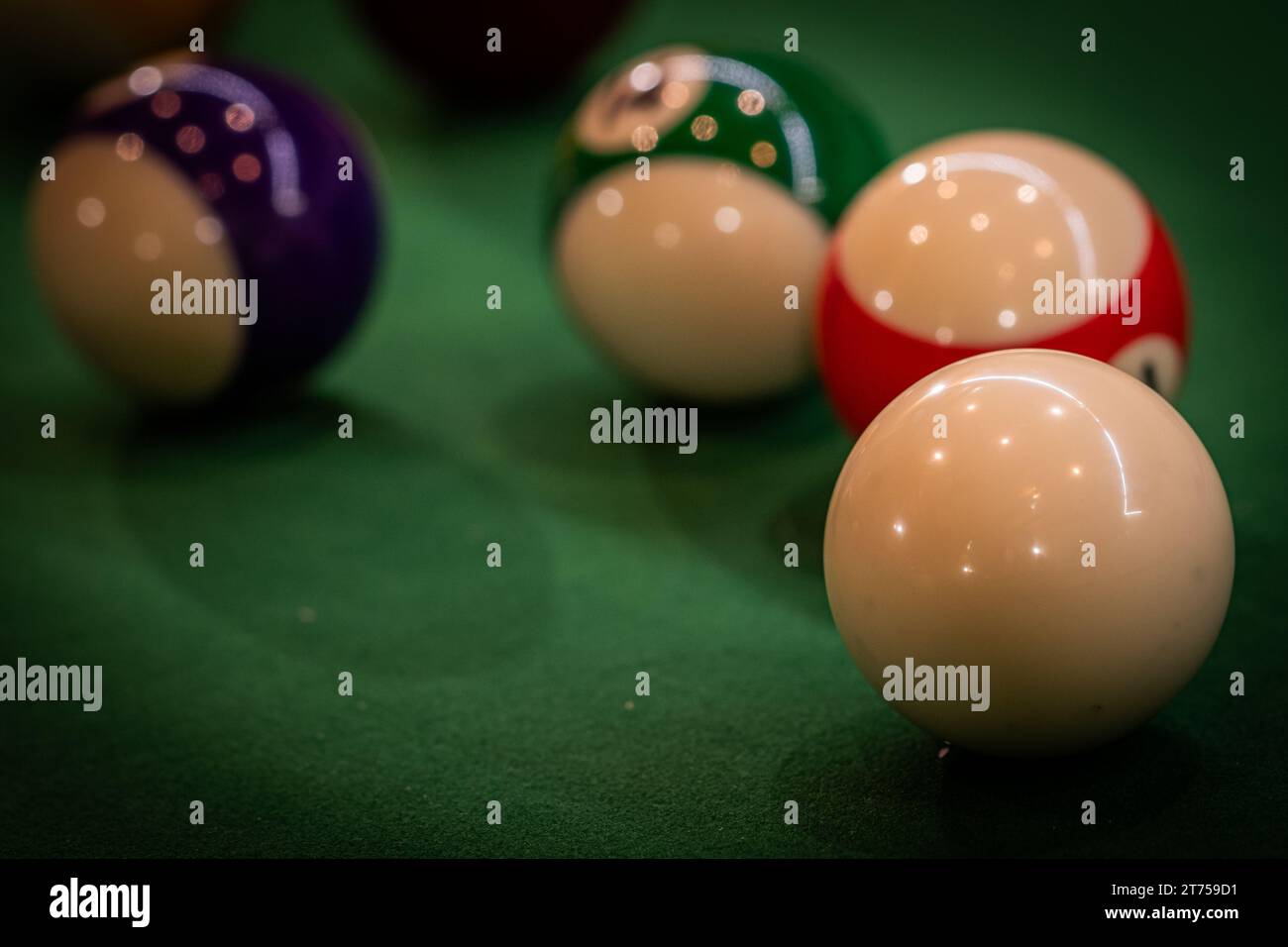 Colorful pool balls arranged on a billiard table, promising ...