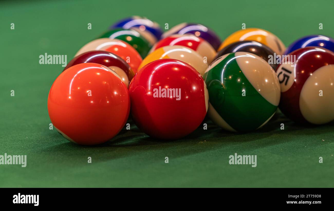 Billiard table setup featuring colorful pool balls, ready for an ...