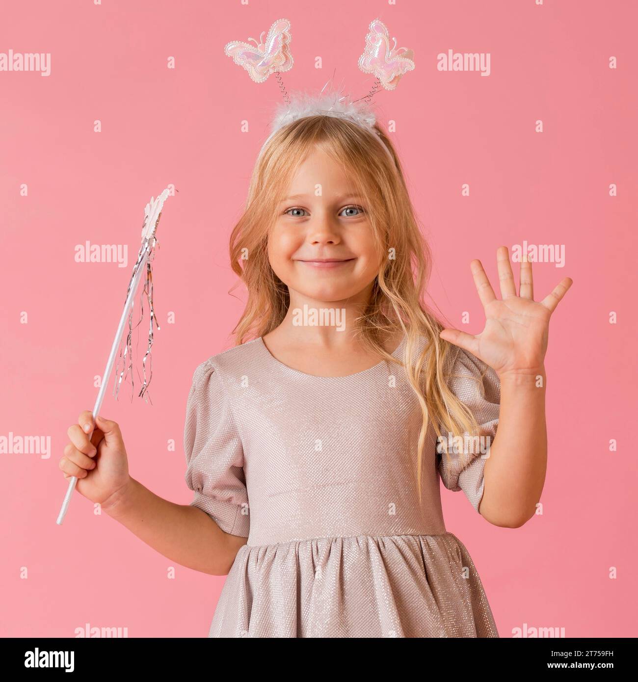 Cute little girl with wand costume Stock Photo - Alamy
