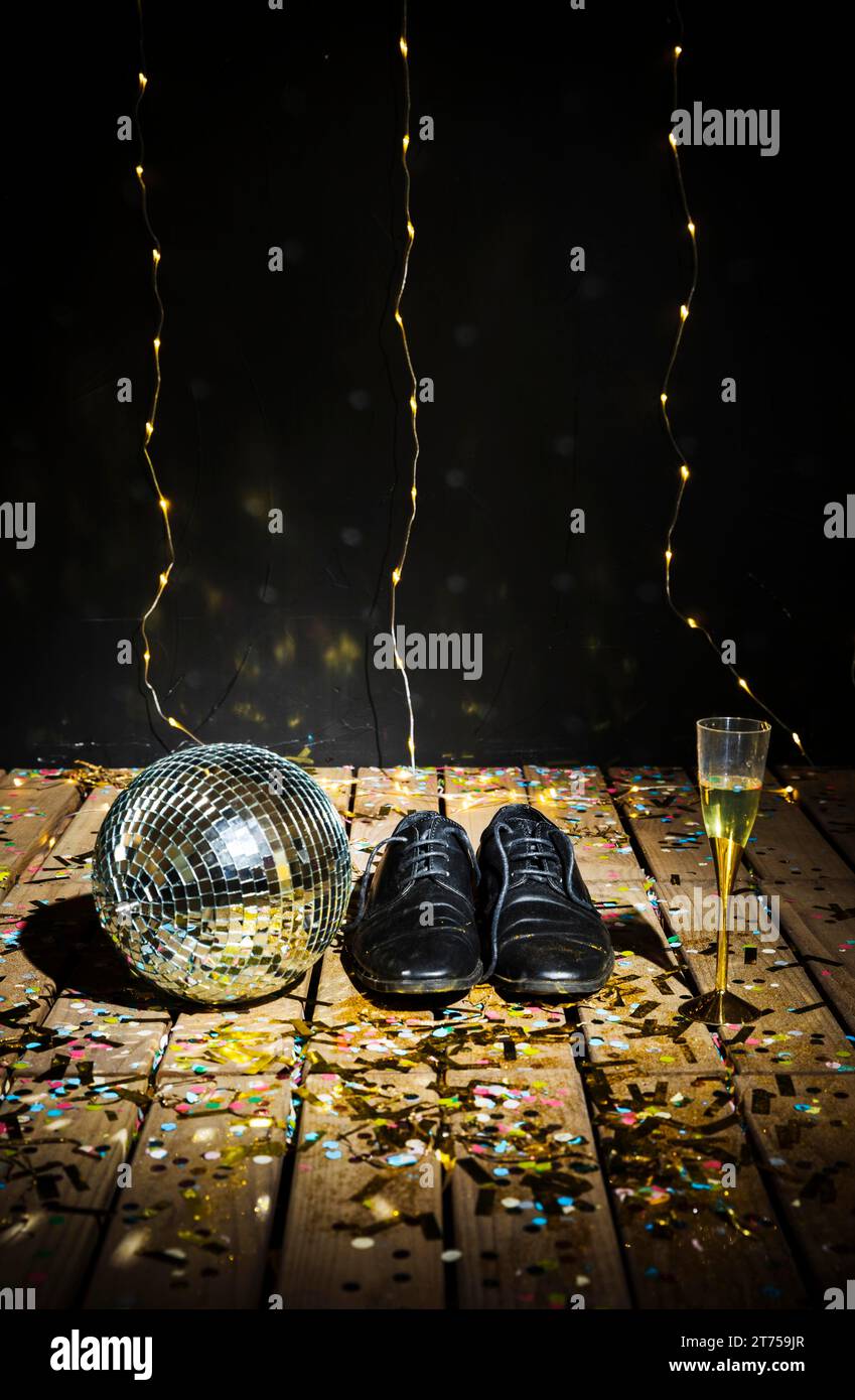 Disco ball man s boots glass drink confetti Stock Photo - Alamy