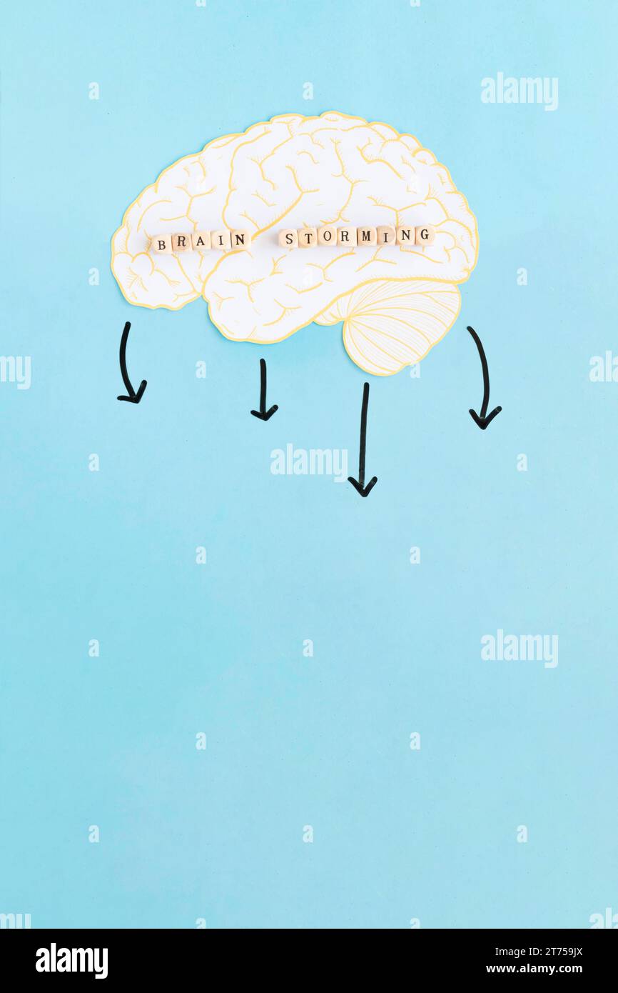 Down arrows falling from white brain with brainstorming blocks against ...