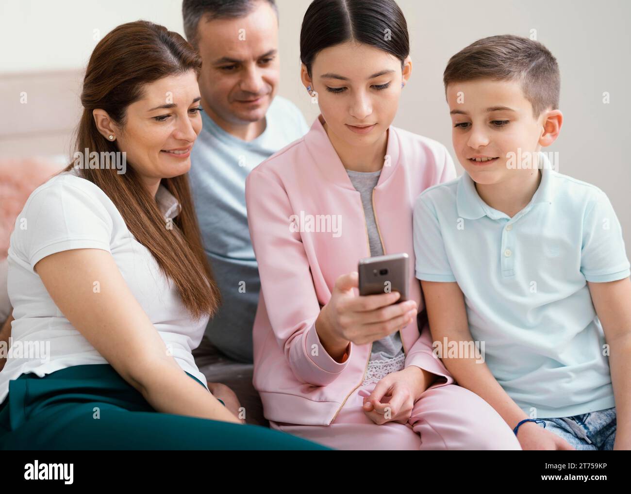 Family members using mobile phone Stock Photo - Alamy