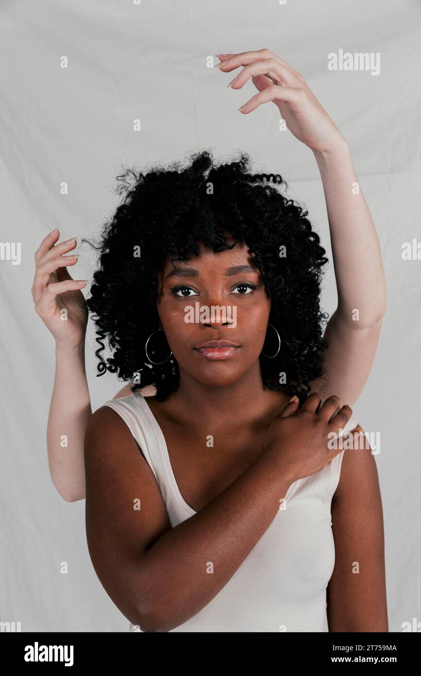 Fair hands african young woman looking camera against grey backdrop ...