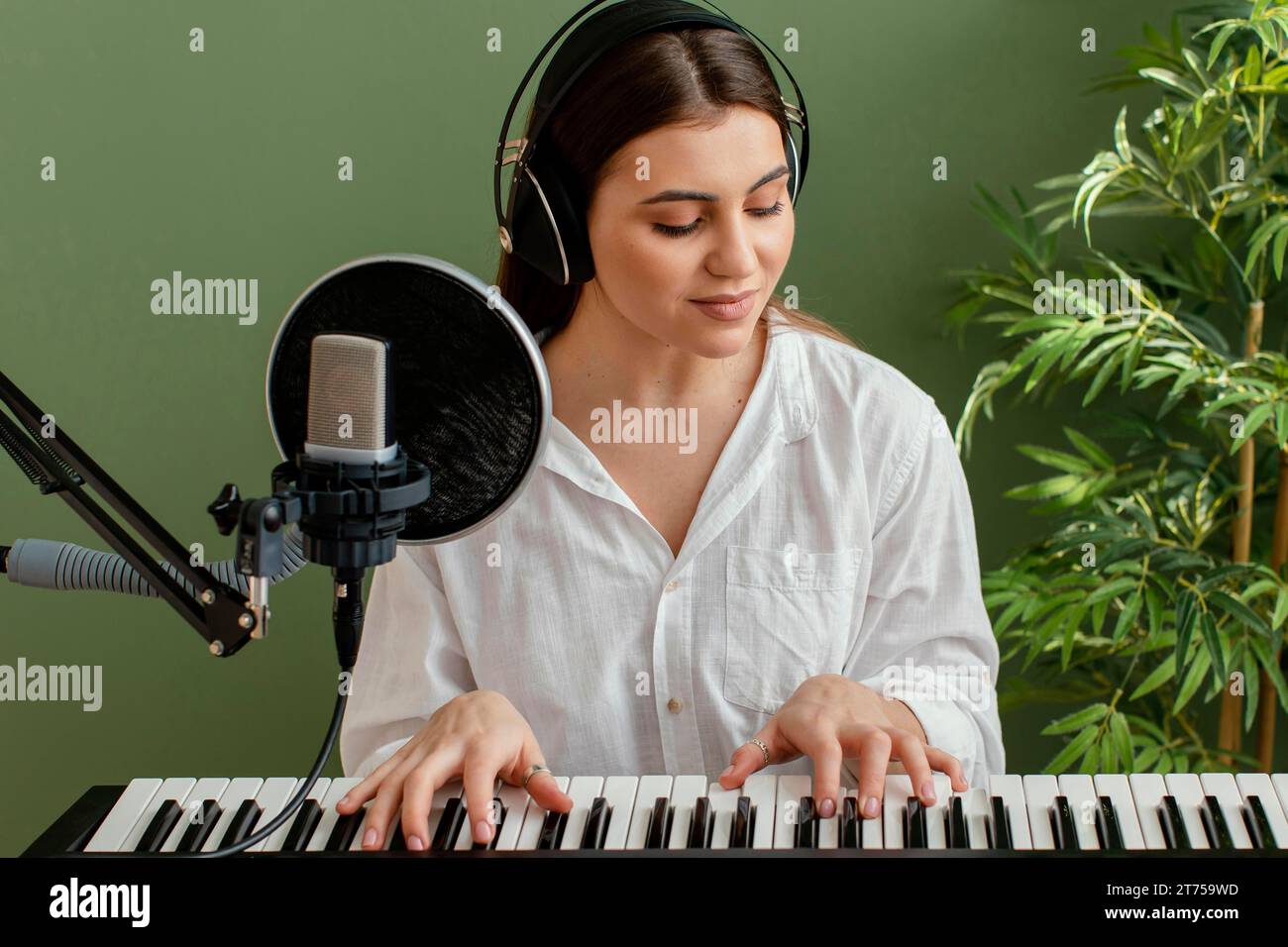 Front view female musician playing piano keyboard Stock Photo - Alamy