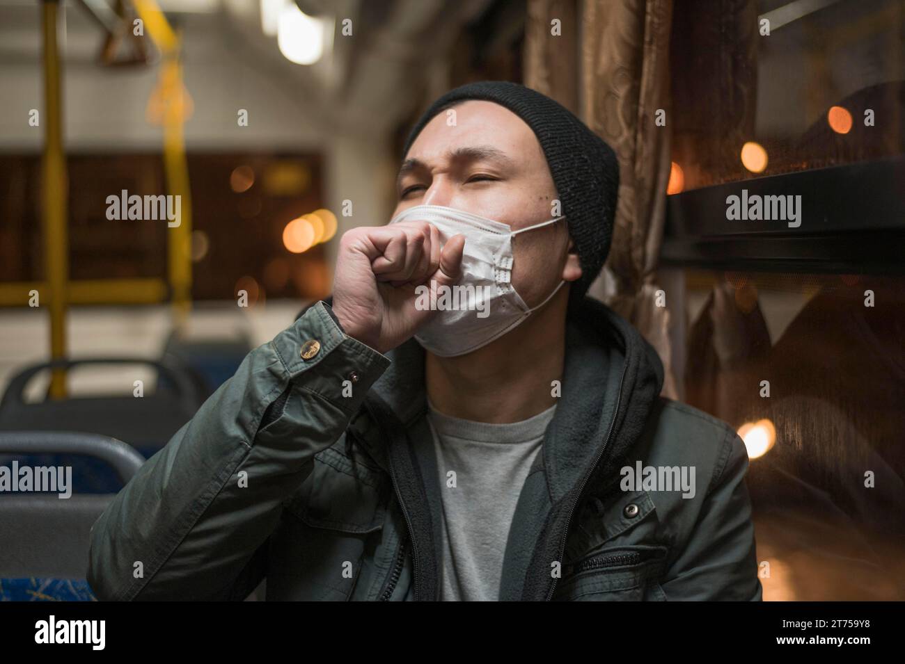 Front view sick man coughing bus while wearing medical mask Stock Photo ...