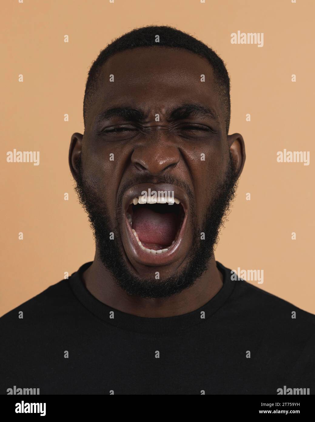 Front view man screaming despair Stock Photo - Alamy