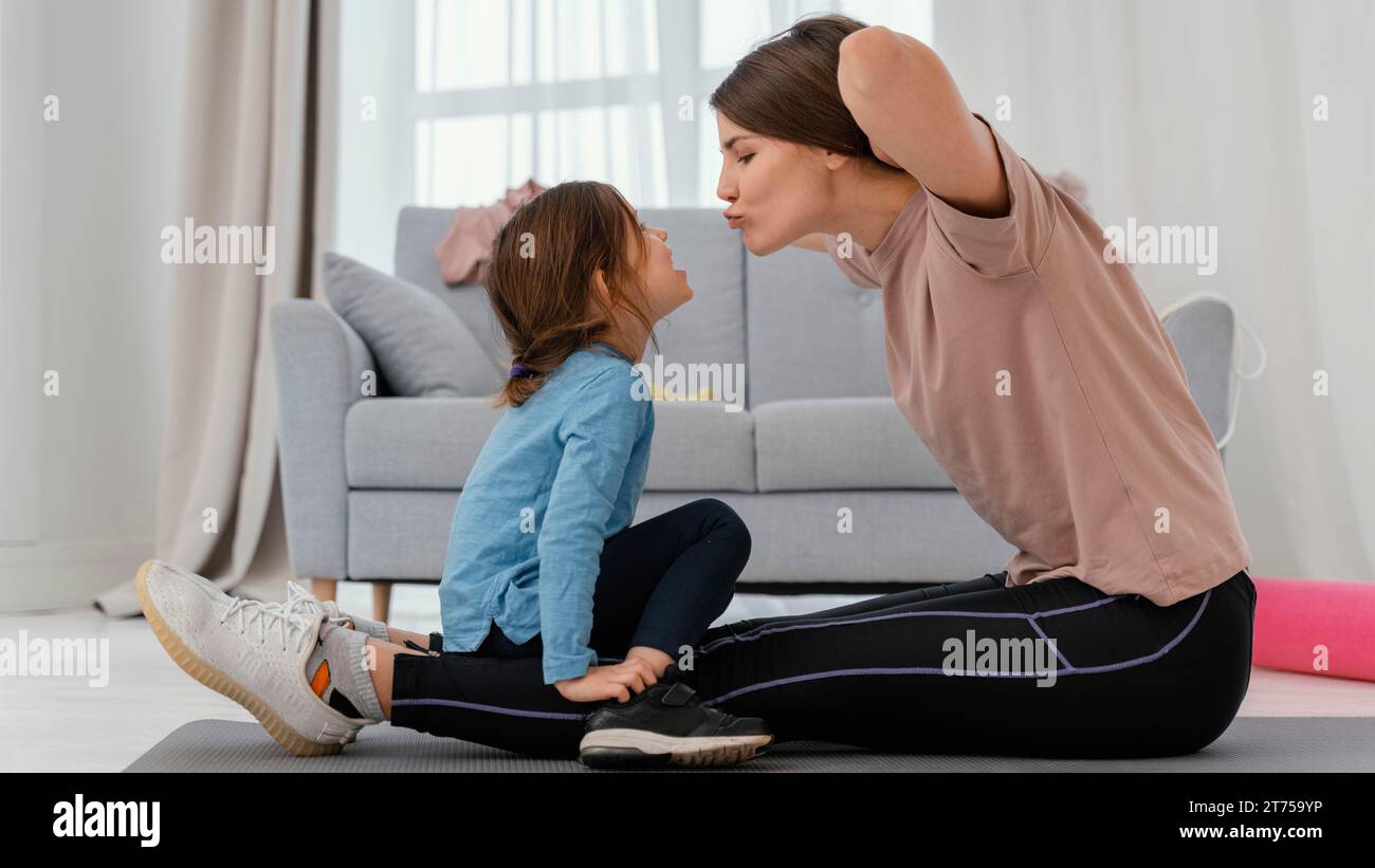 Full shot mother training with child Stock Photo - Alamy