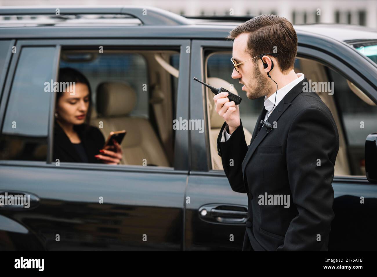 Guard man ensuring client safety Stock Photo - Alamy