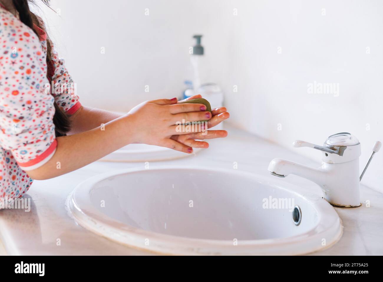 Girl using soap her hands bathroom Stock Photo - Alamy
