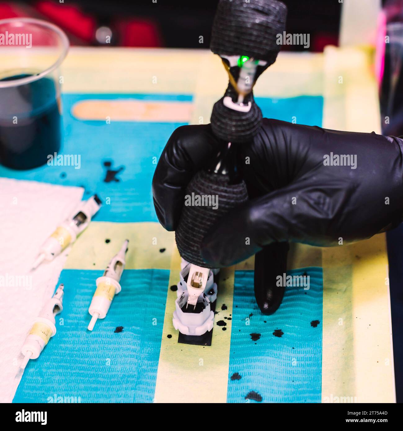 Hand dipping tattoo pen paint Stock Photo - Alamy