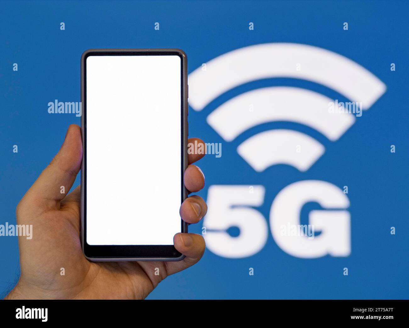 Hand holding phone with 5g symbol background Stock Photo - Alamy