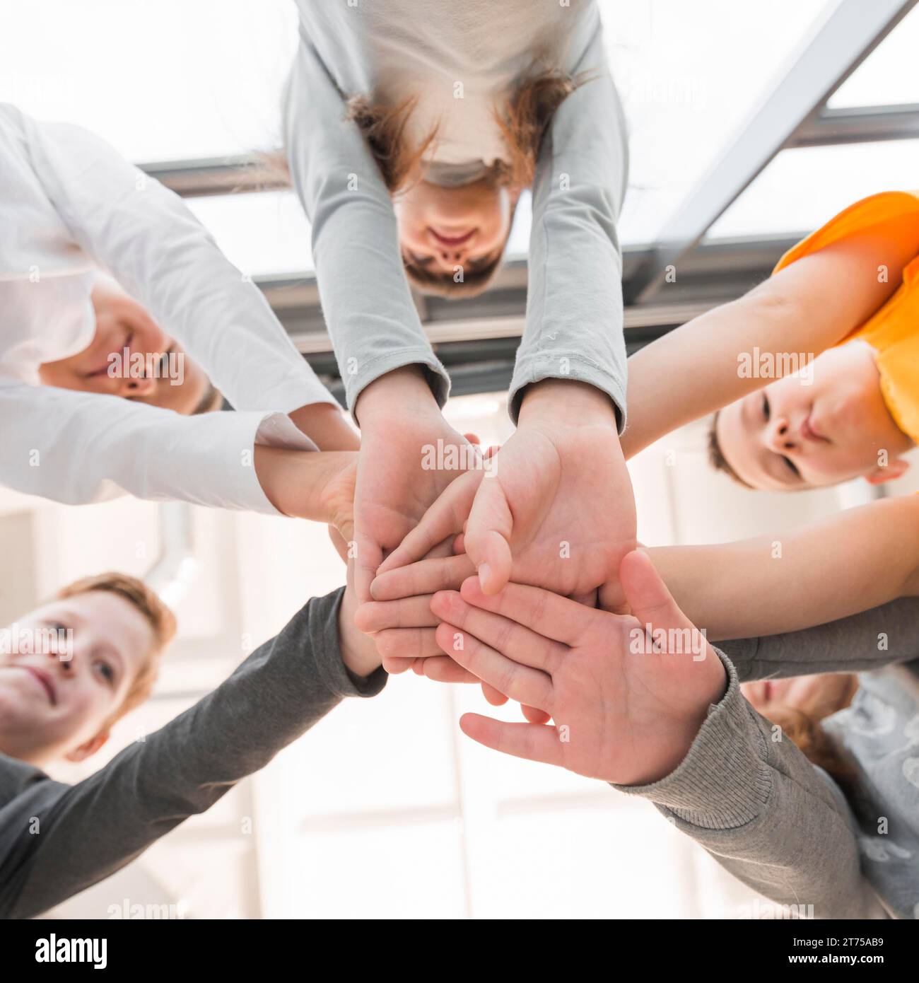 Kids putting their hands together Stock Photo - Alamy