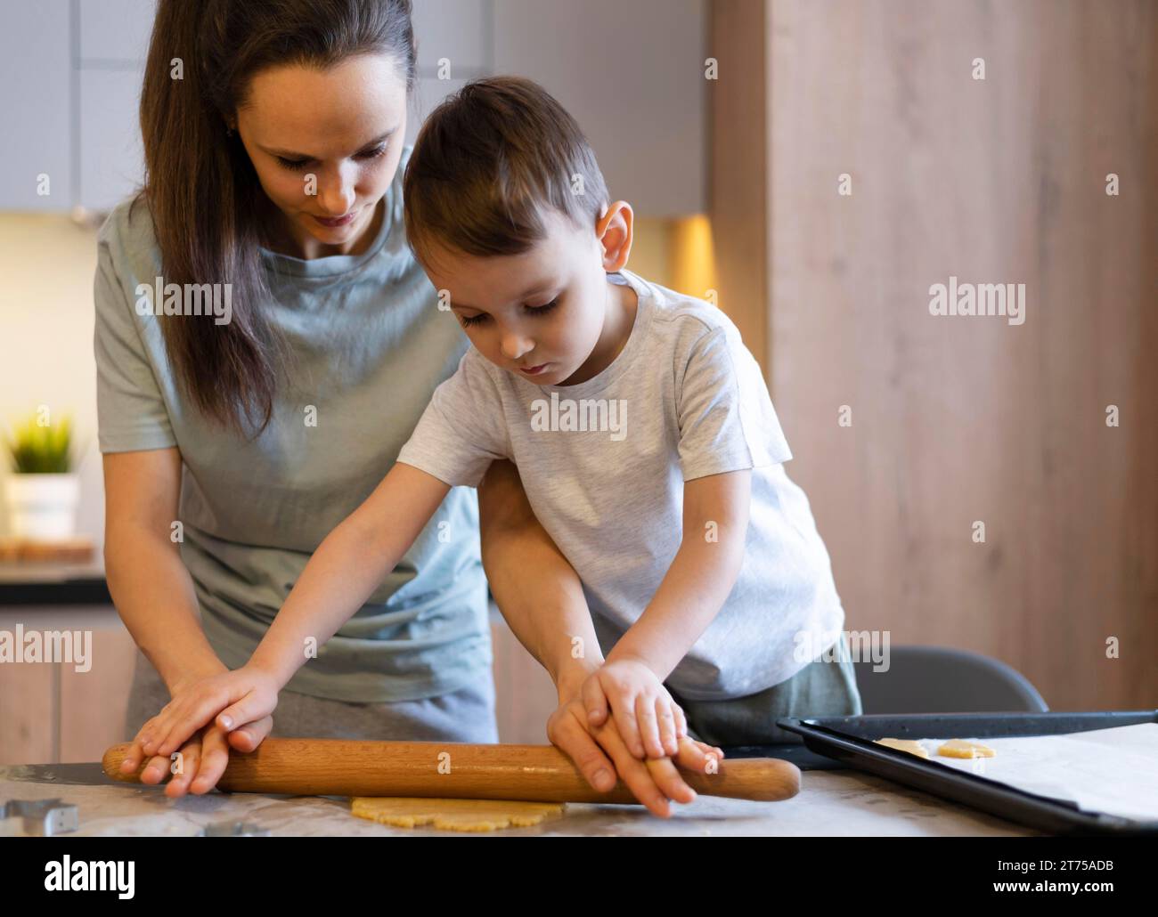 Medium shot kid woman using rolling pin Stock Photo - Alamy