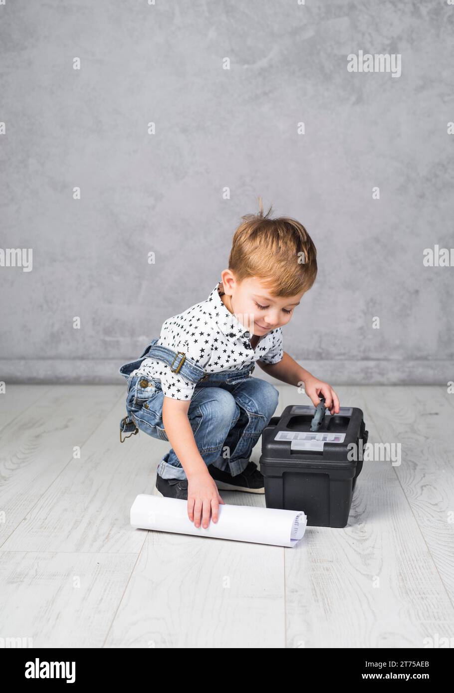 Little boy with tool box paper roll Stock Photo - Alamy