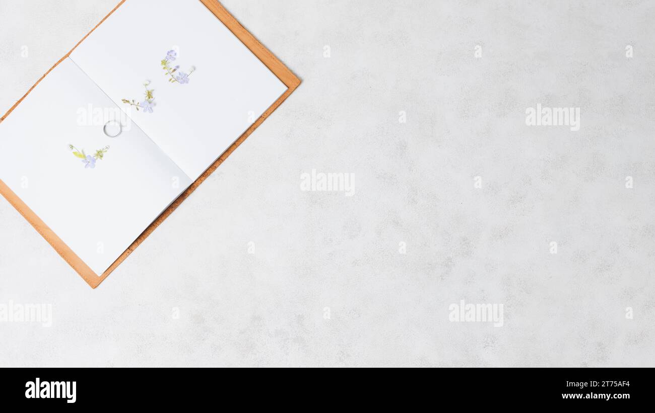 Love text made with wedding ring open book concrete backdrop Stock ...