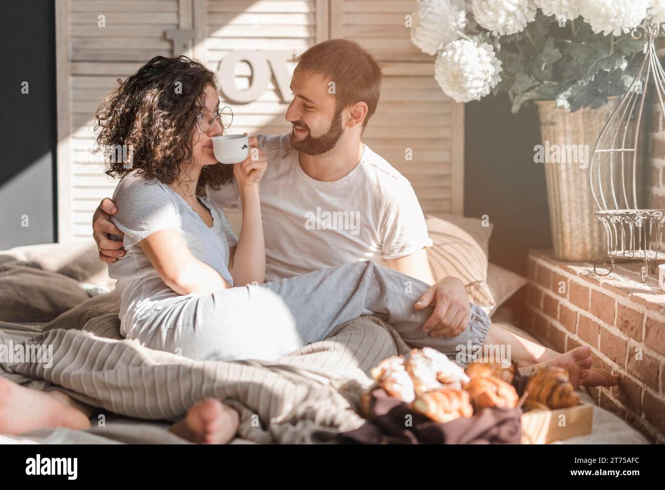 Man looking woman sitting man s lap drinking coffee morning Stock Photo ...