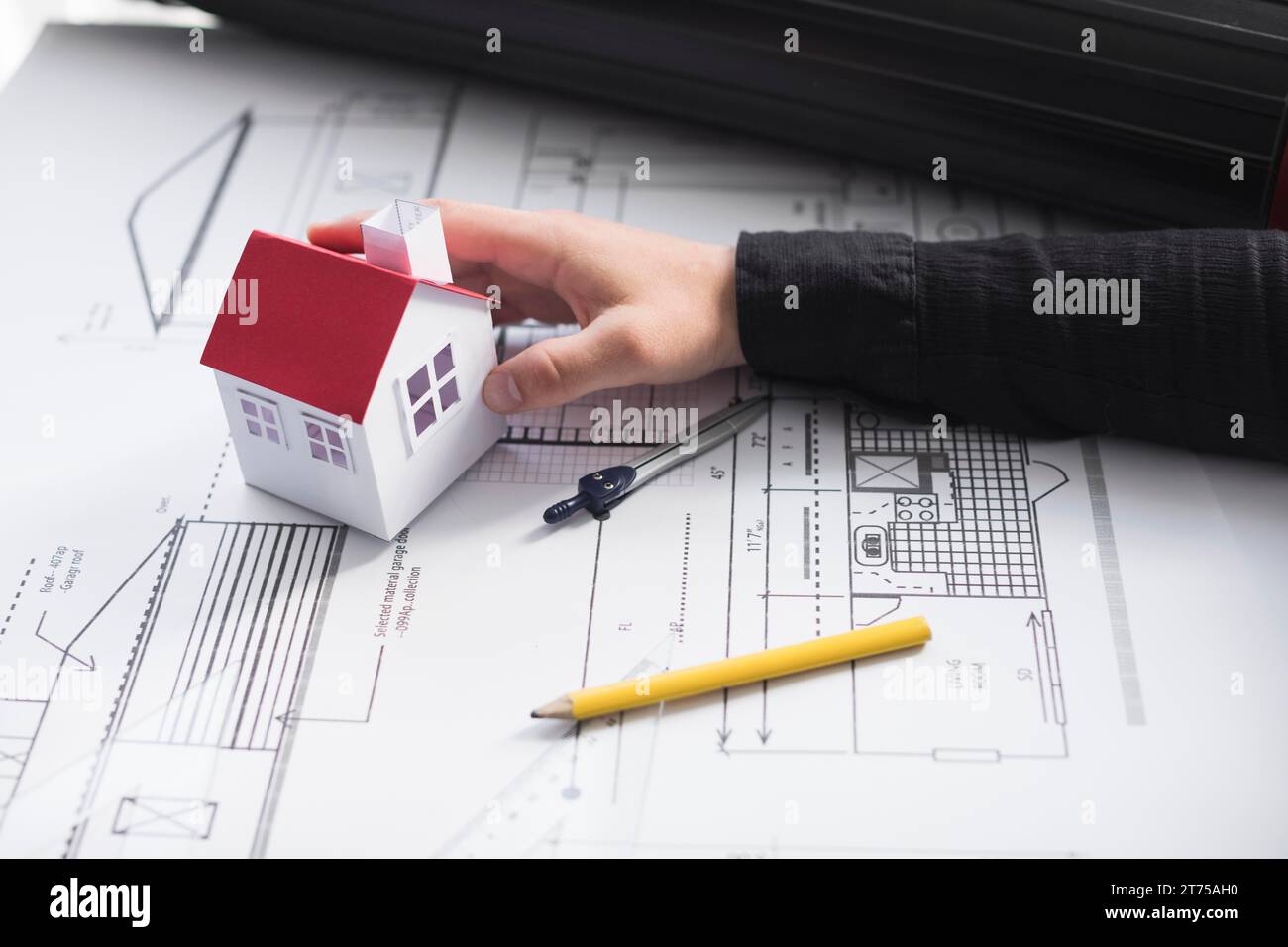 Man s hand holding house model blueprint office Stock Photo - Alamy