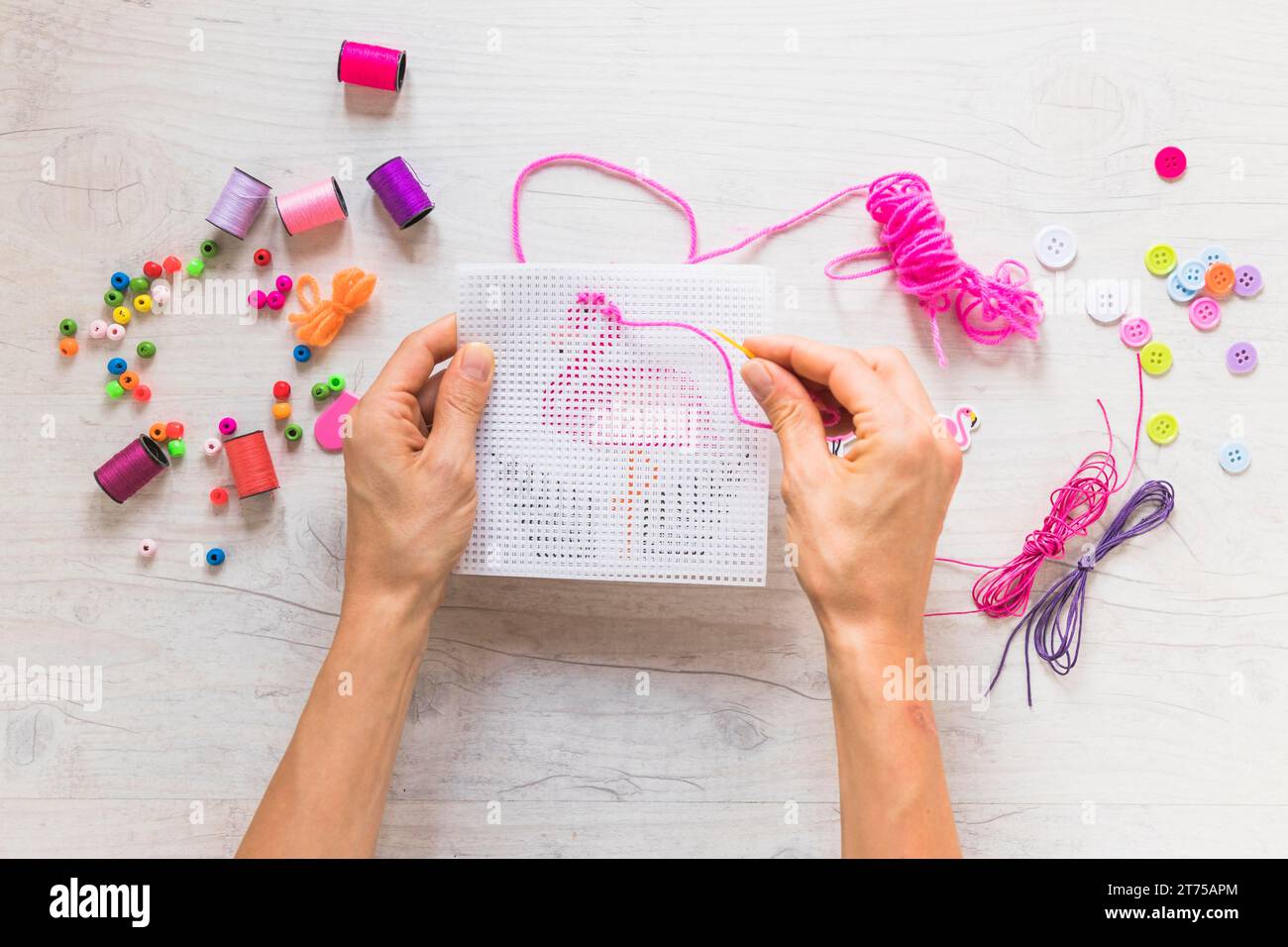 Person hand s doing embroidery with decorative elements textured ...