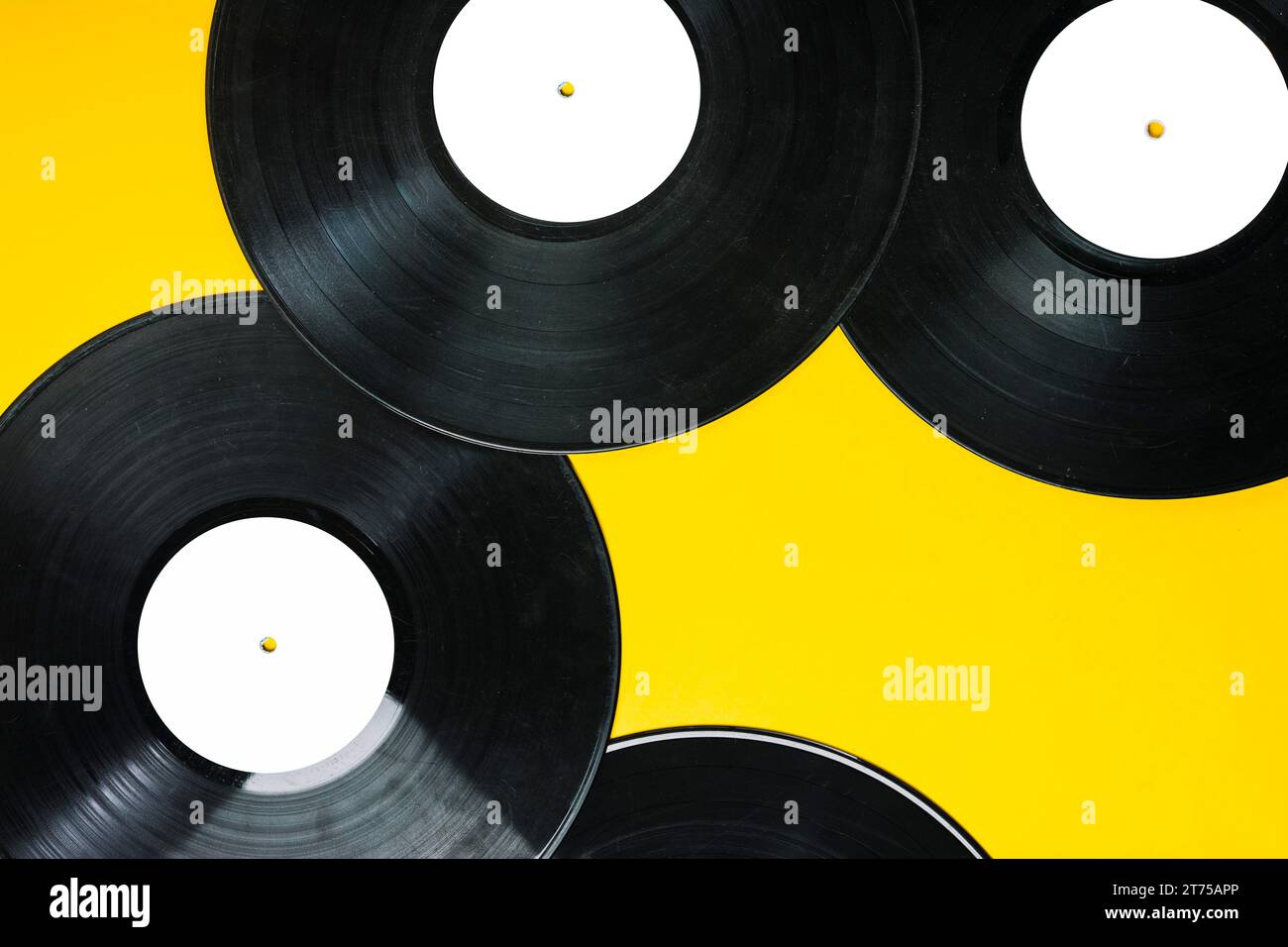 Overhead view vinyl records yellow background Stock Photo - Alamy