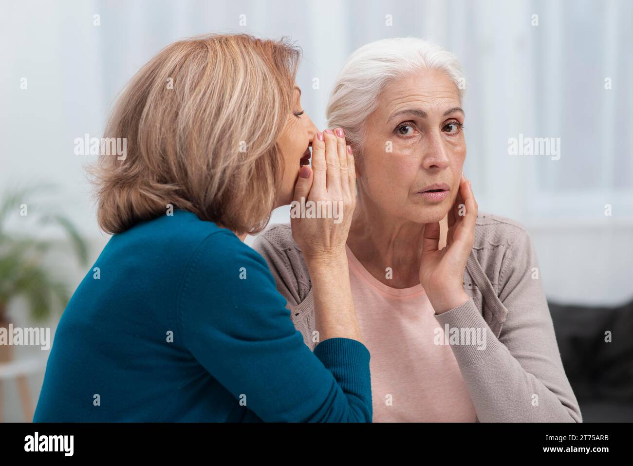 Women gossip whisper hi-res stock photography and images - Alamy