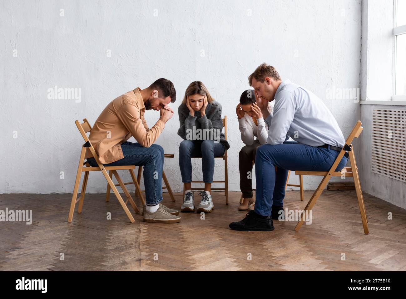 Sad people chairs group therapy session Stock Photo - Alamy
