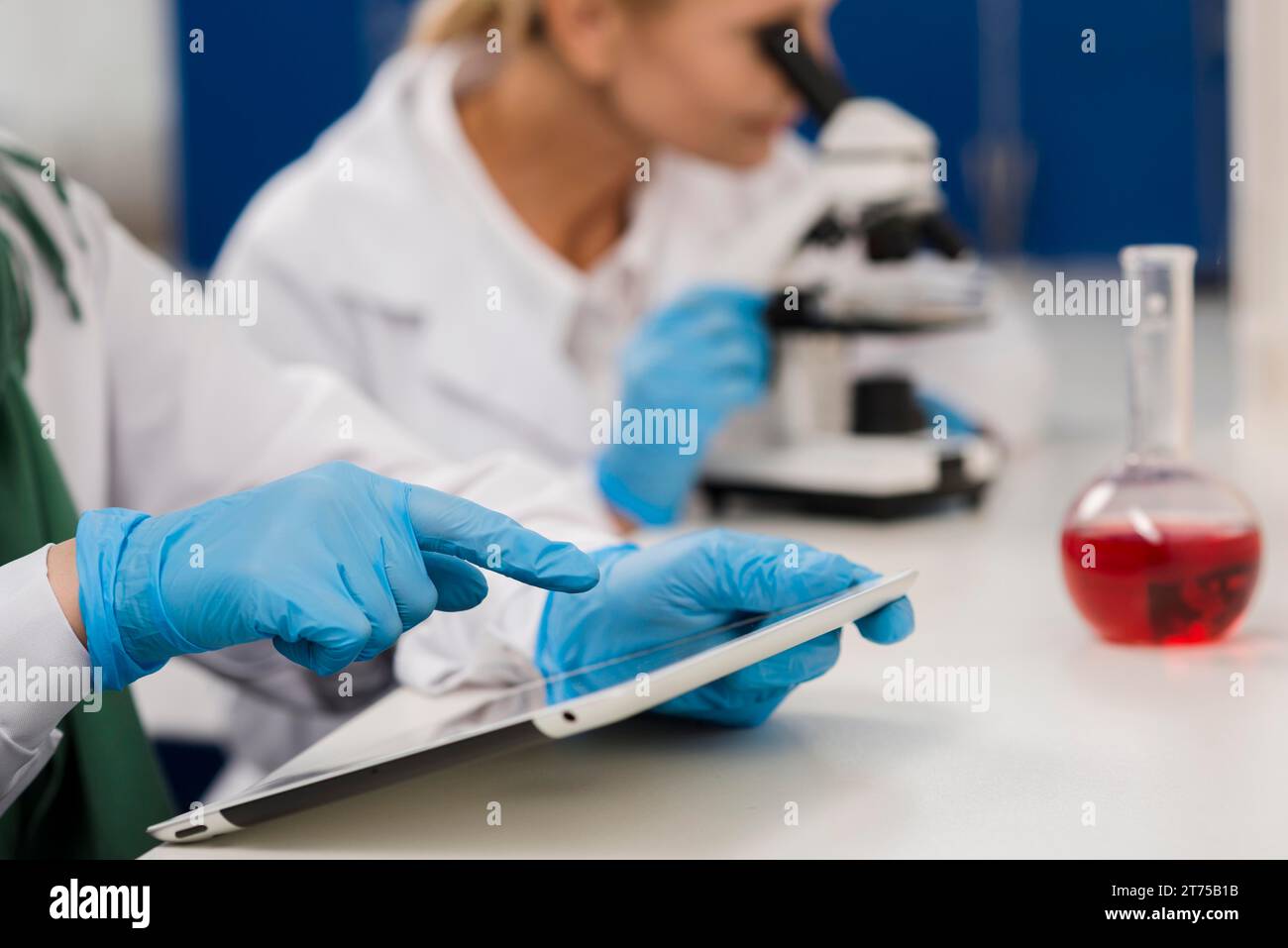 Side view female scientists lab working with microscope tablet Stock Photo - Alamy