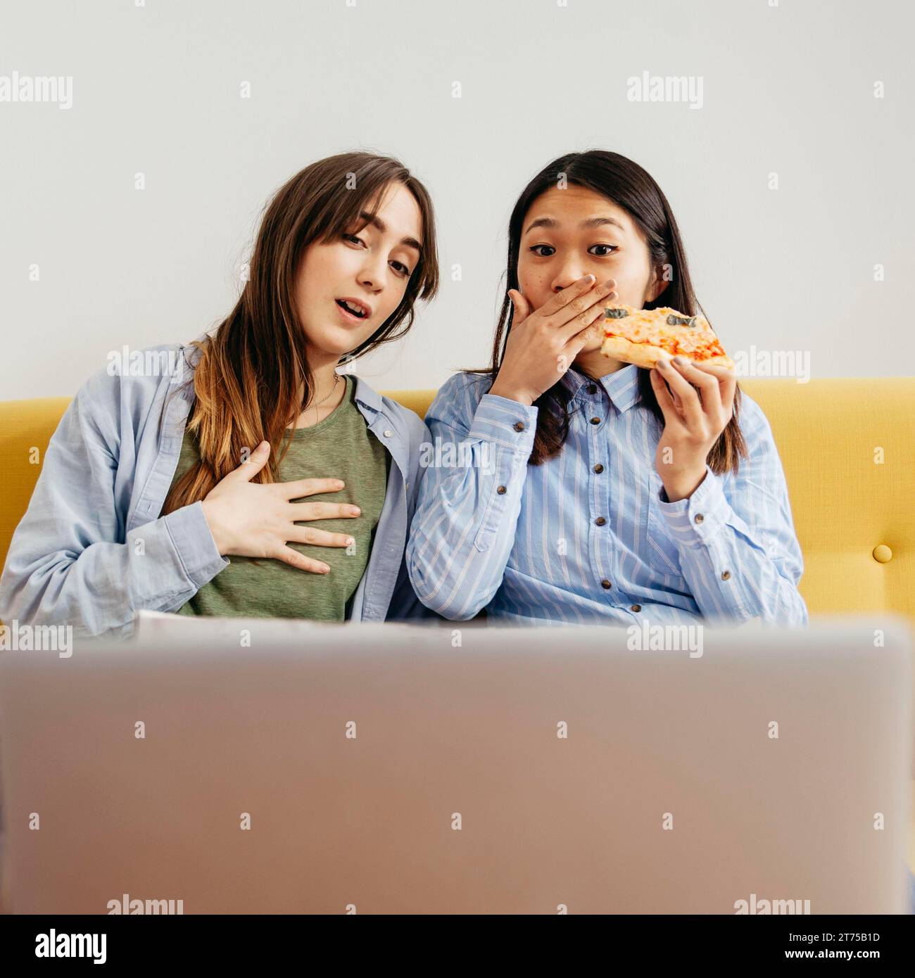 Scared girls watching movie Stock Photo - Alamy