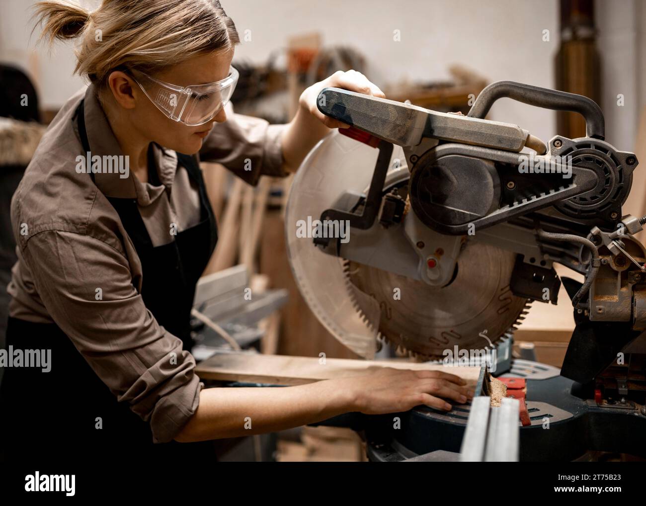 Side view female carpenter with safety glasses tool Stock Photo - Alamy