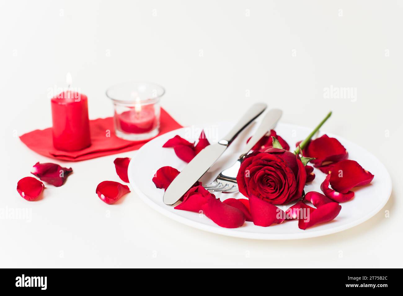 Red rose with cutlery plate Stock Photo - Alamy