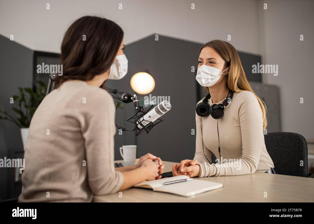 Smiley women doing radio with medical masks Stock Photo - Alamy