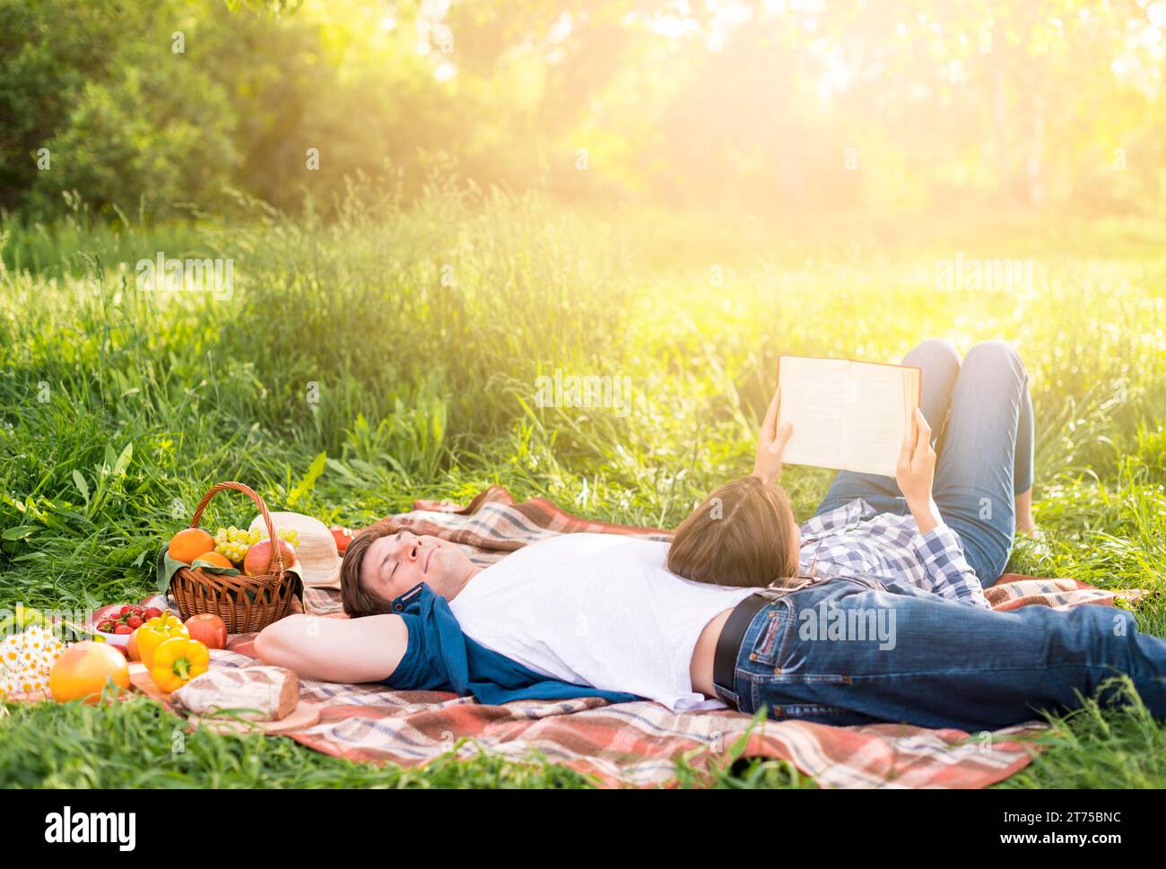 Woman leaning boyfriend reading book Stock Photo - Alamy