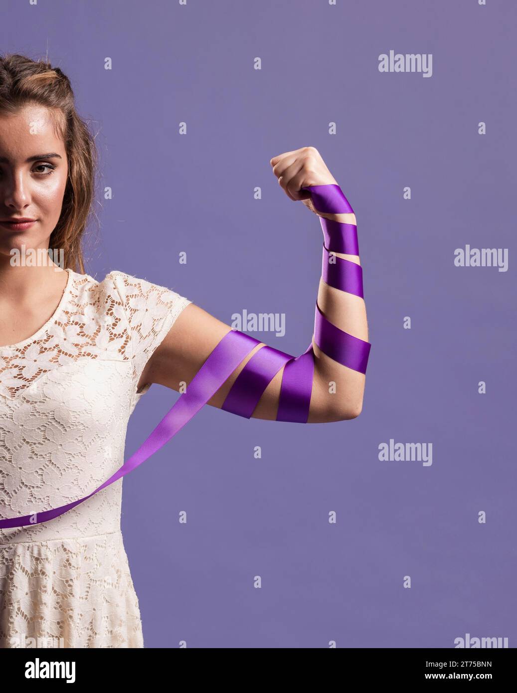 Woman flexing her arm with ribbon suppport feminism Stock Photo - Alamy